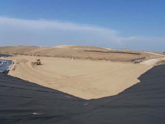 Designing Landfill Cell Base Slopes with Transmissivity